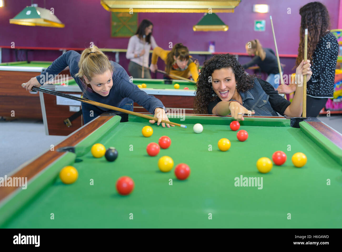 Two women playing pool Stock Photo - Alamy