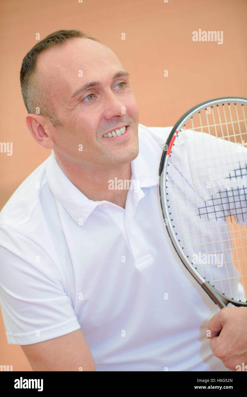 Portrait of man holding tennis racket Stock Photo - Alamy