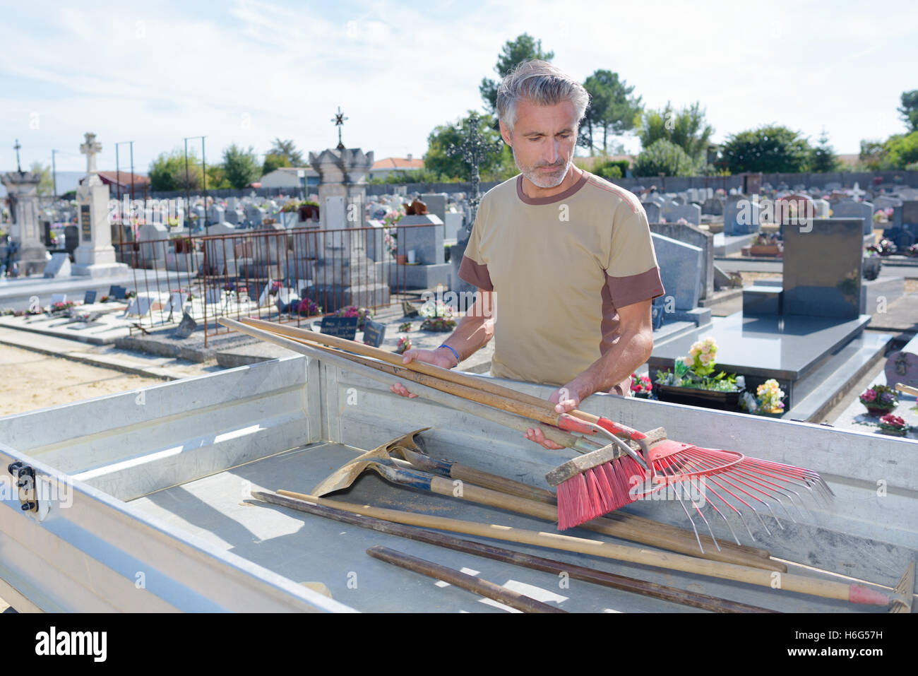 graveyard maintenance personnel Stock Photo - Alamy