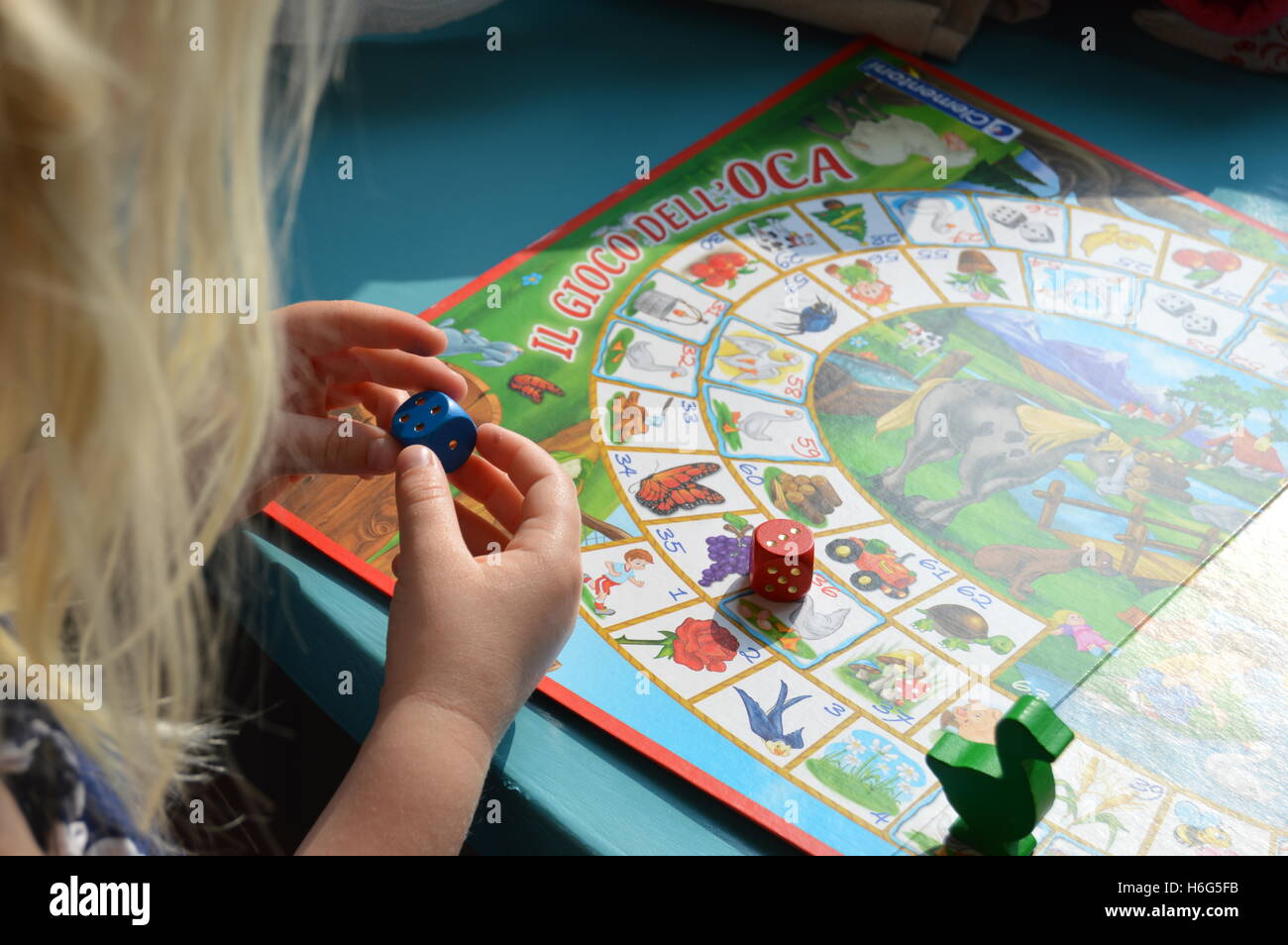 Child playing game with die Stock Photo - Alamy