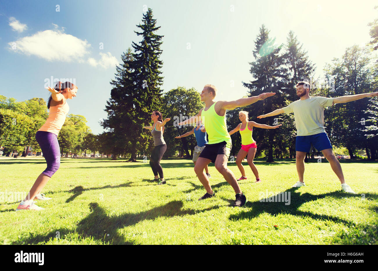 group of happy friends exercising outdoors Stock Photo - Alamy