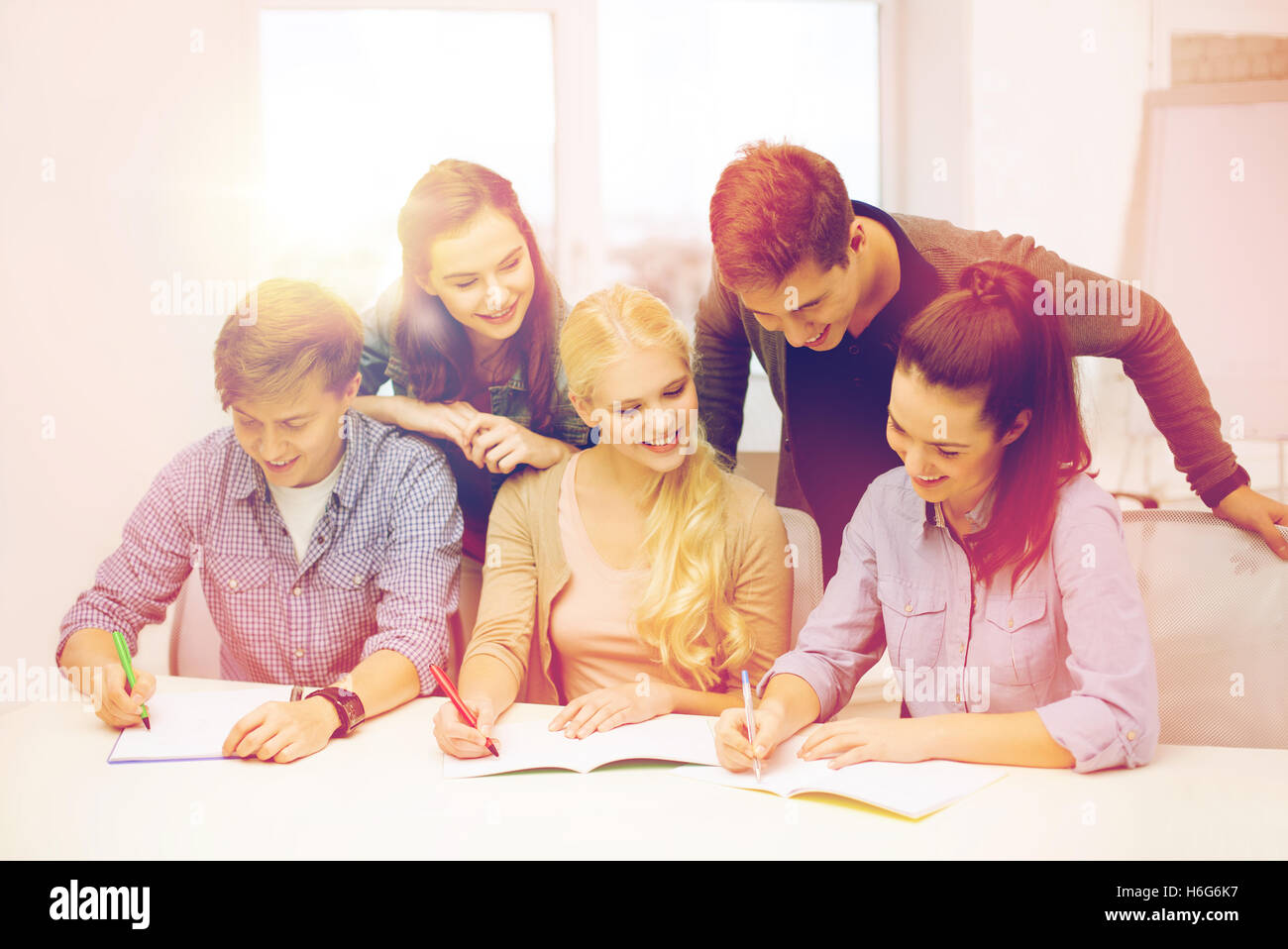 smiling students with notebooks at school Stock Photo - Alamy