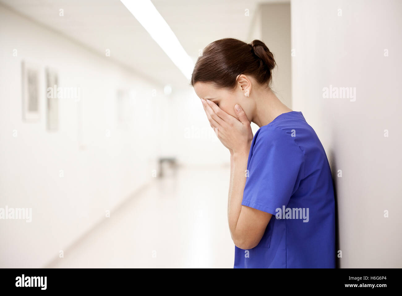 sad or crying female nurse at hospital corridor Stock Photo - Alamy