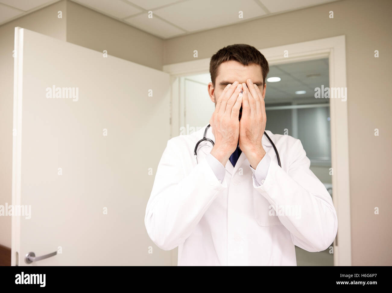 sad or crying male doctor at hospital ward Stock Photo - Alamy