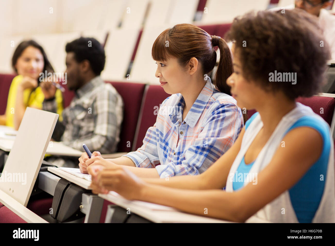 group of students talking in lecture hall Stock Photo - Alamy