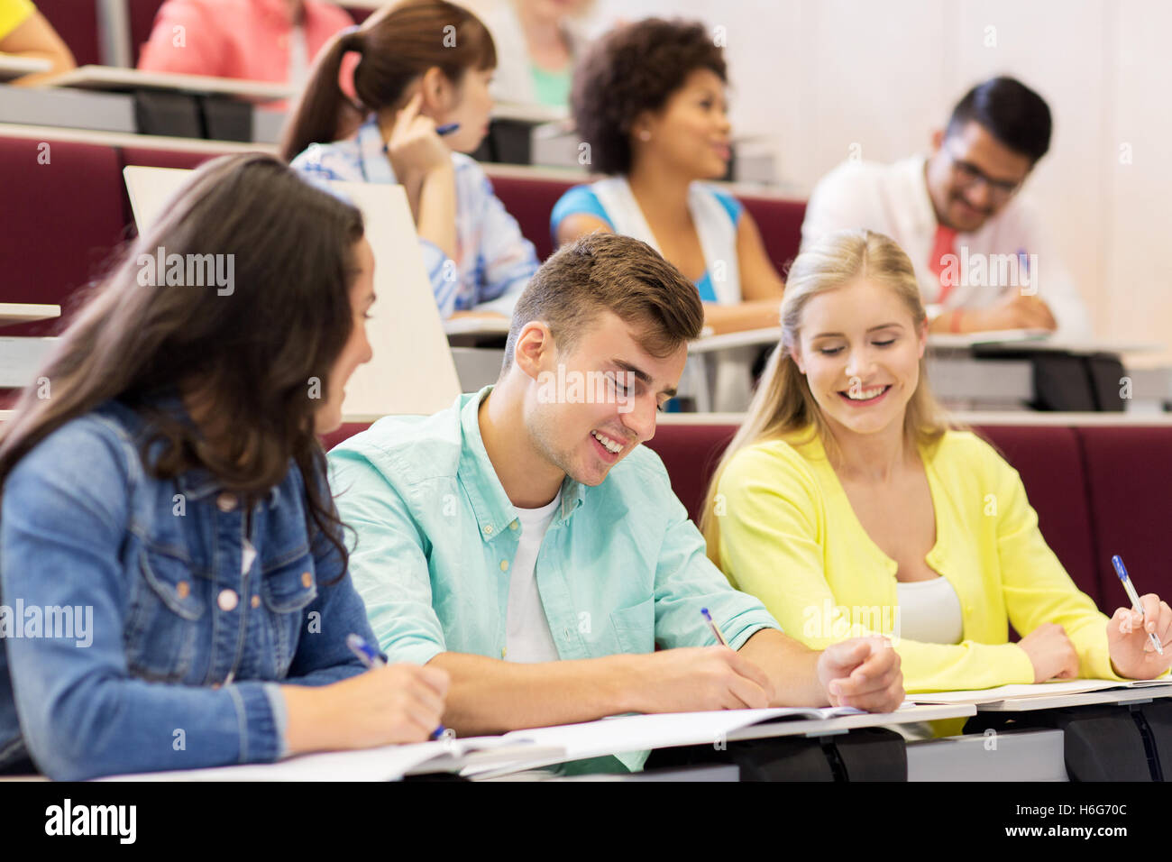 group of students with notebooks in lecture hall Stock Photo - Alamy