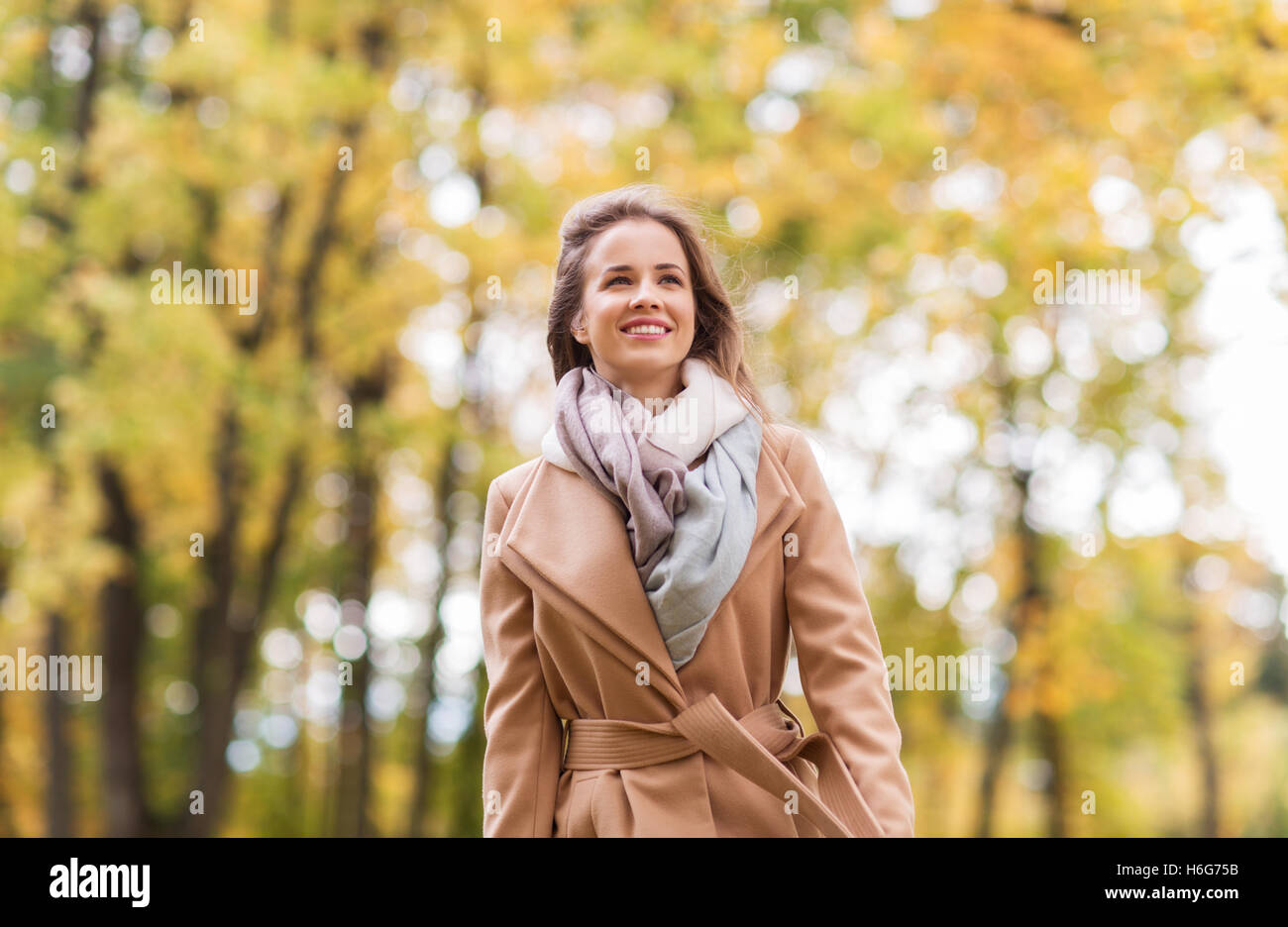 beautiful happy young woman walking in autumn park Stock Photo - Alamy