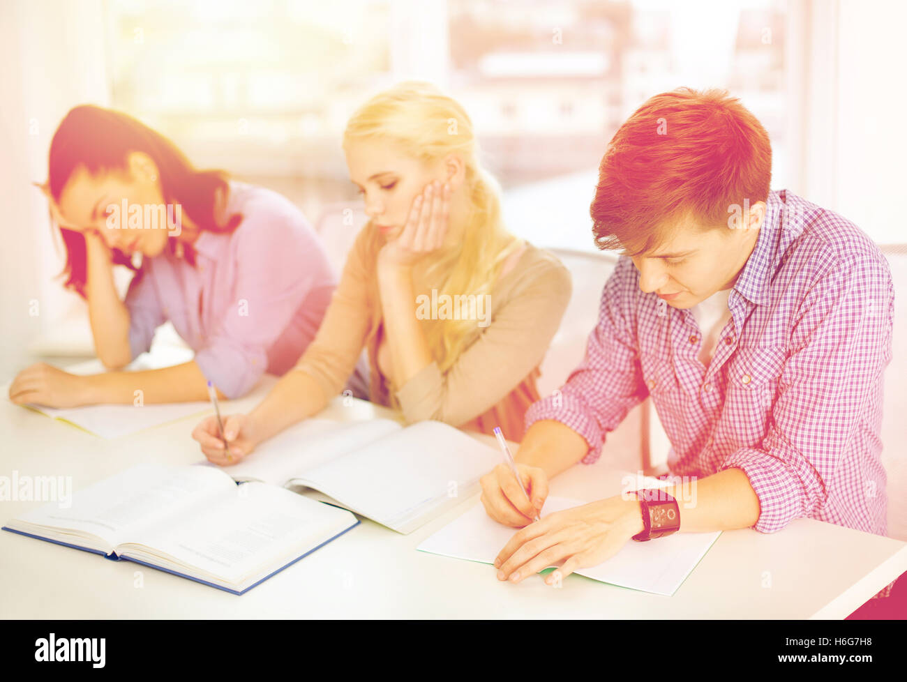 tired students with notebooks at school Stock Photo - Alamy
