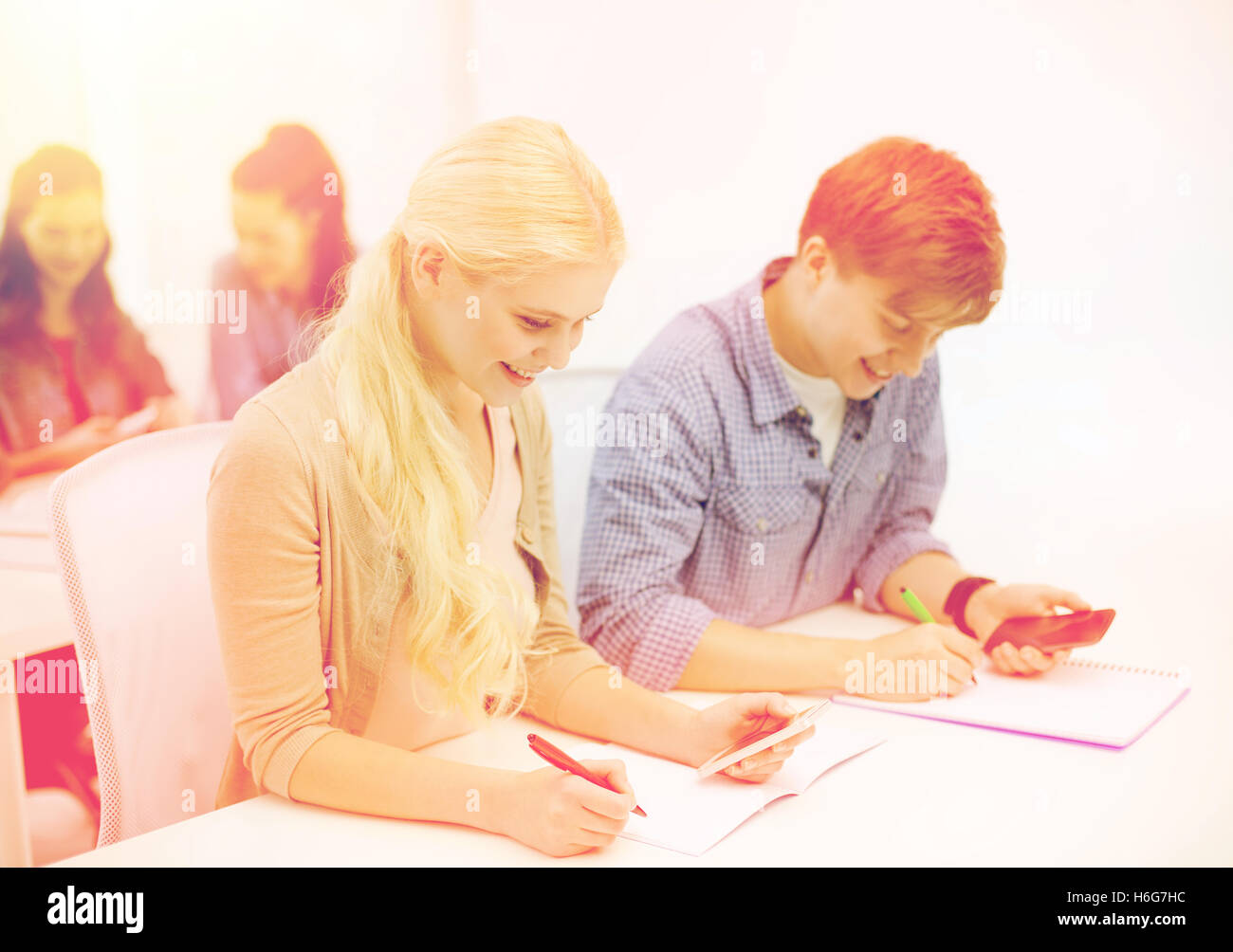 smiling students with notebooks at school Stock Photo - Alamy