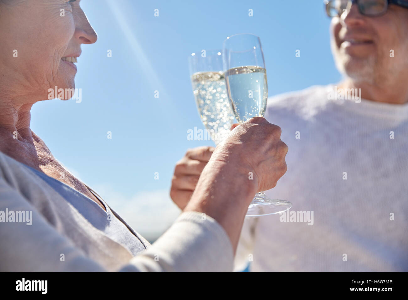 happy senior couple drinking champagne outdoors Stock Photo - Alamy