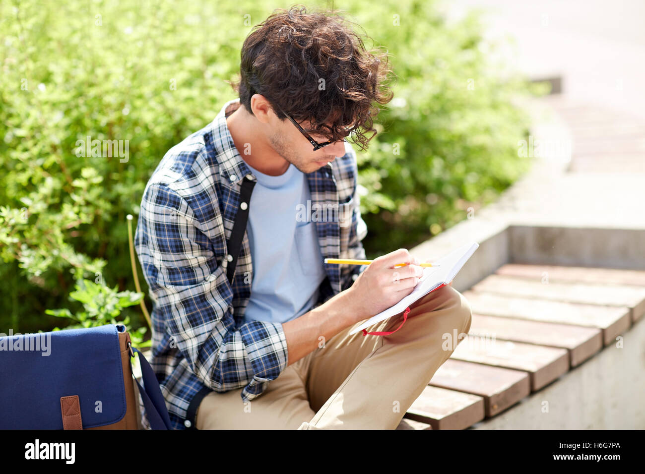 man with notebook or diary writing on city street Stock Photo - Alamy