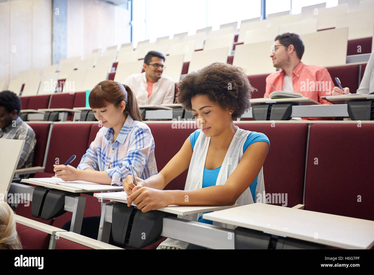 group of students with notebooks at lecture hall Stock Photo - Alamy