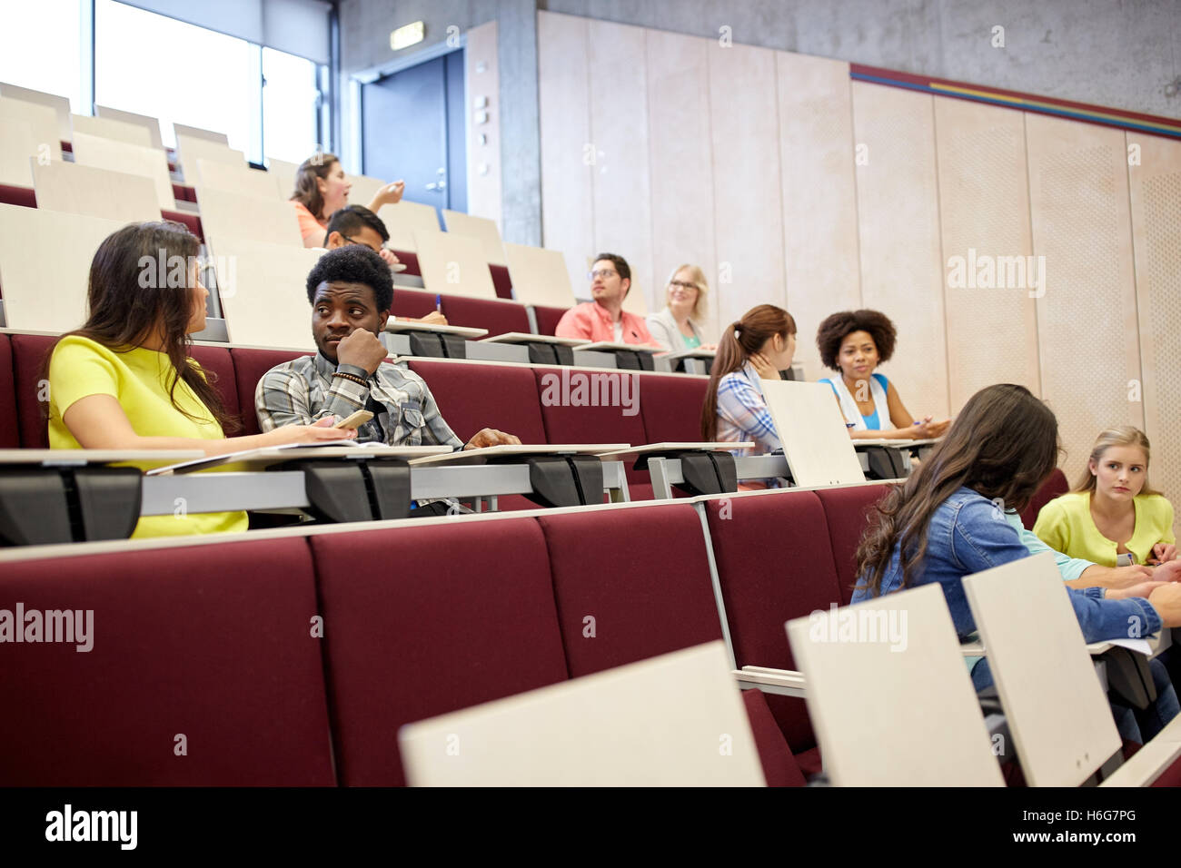group of students with notebooks at lecture hall Stock Photo - Alamy