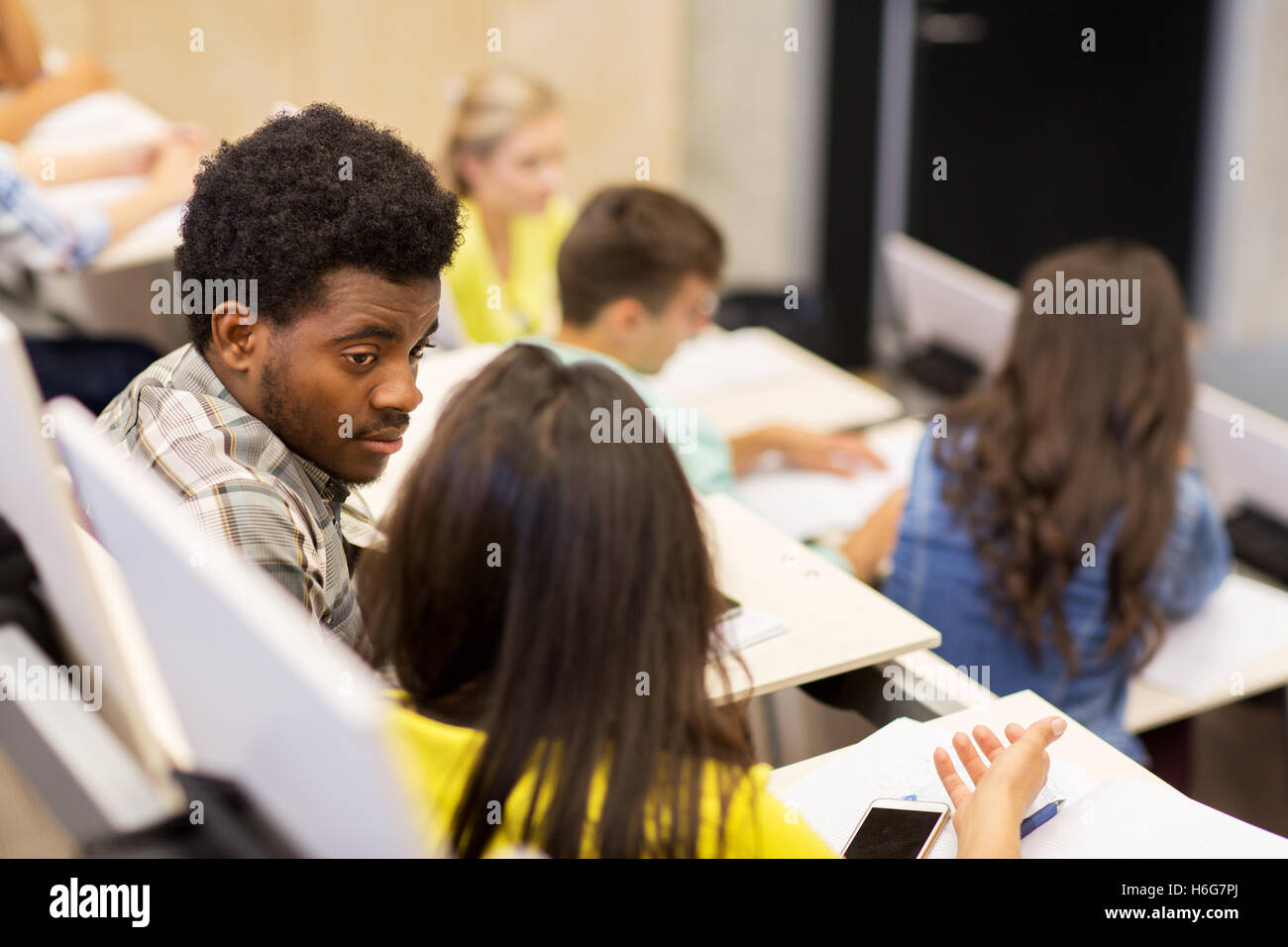 group of students talking in lecture hall Stock Photo - Alamy