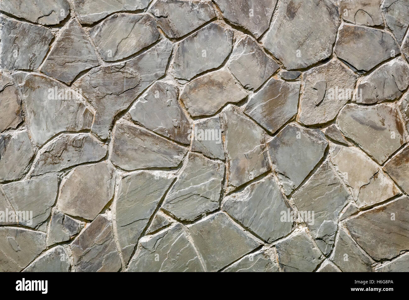 Fragment of the ancient stone wall executed from stones of various form ...