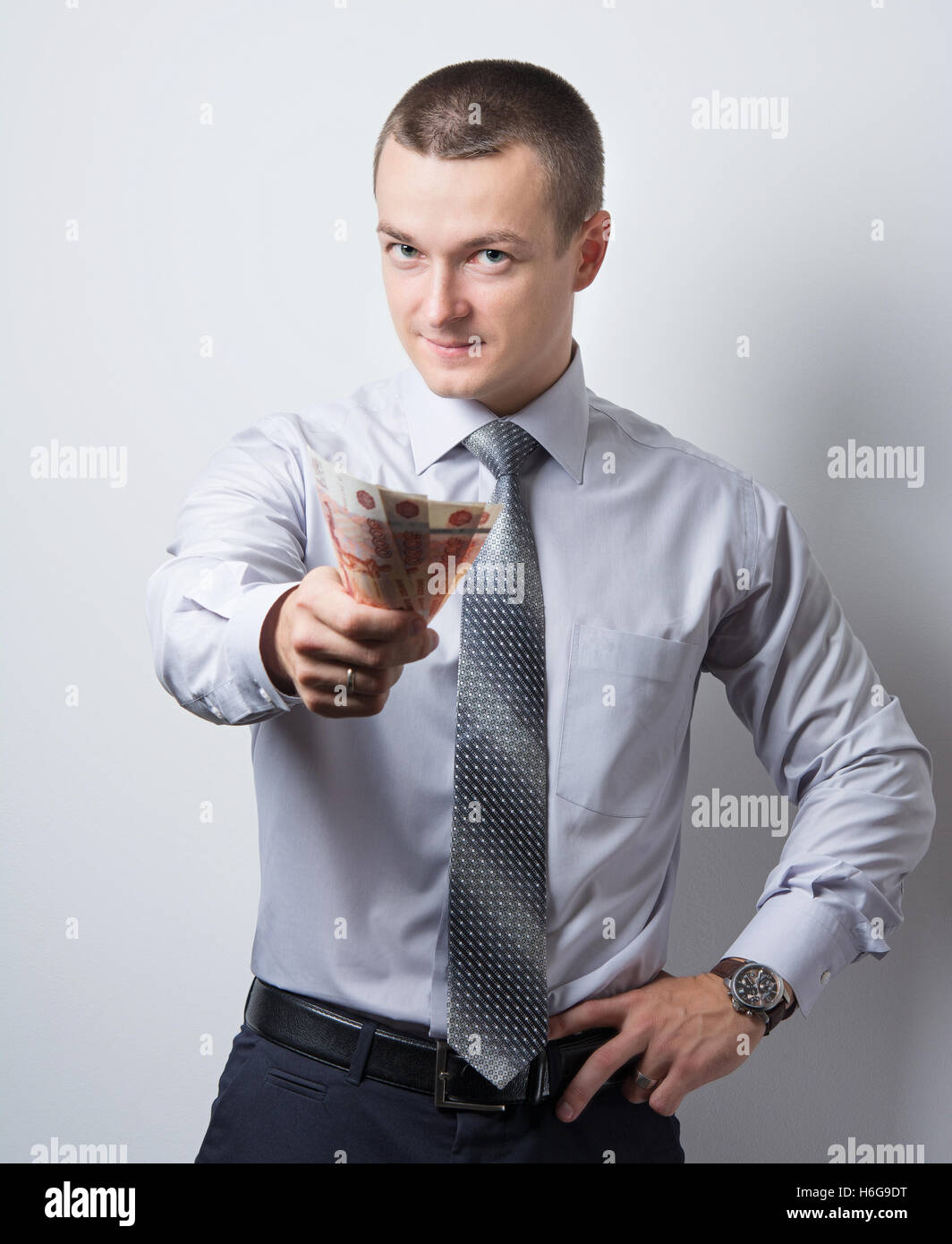 young Manager offers money cash Stock Photo - Alamy