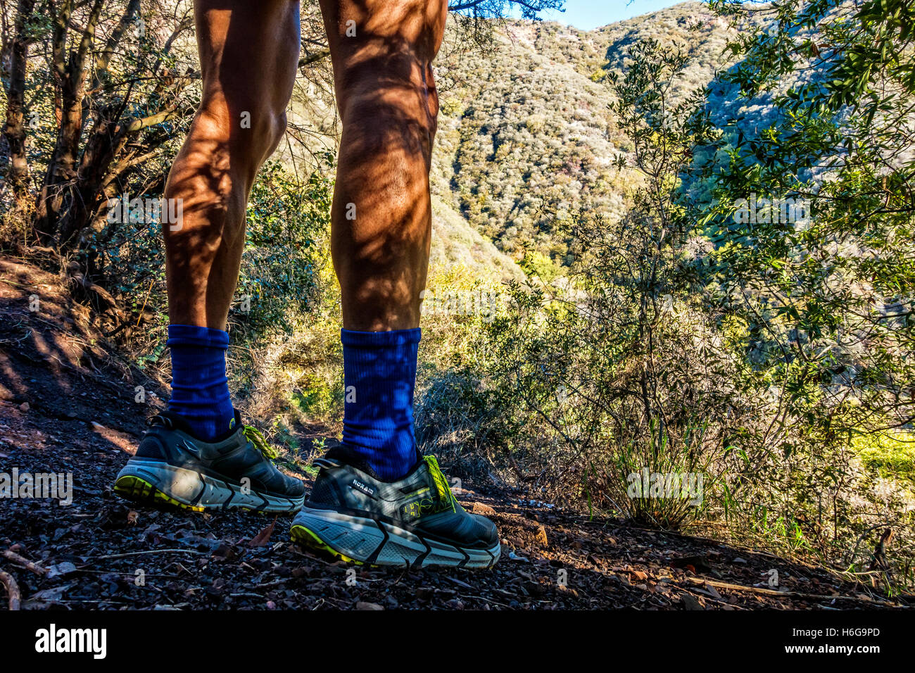 Runner on Romero Canyon fire road and trail in the mountains above ...