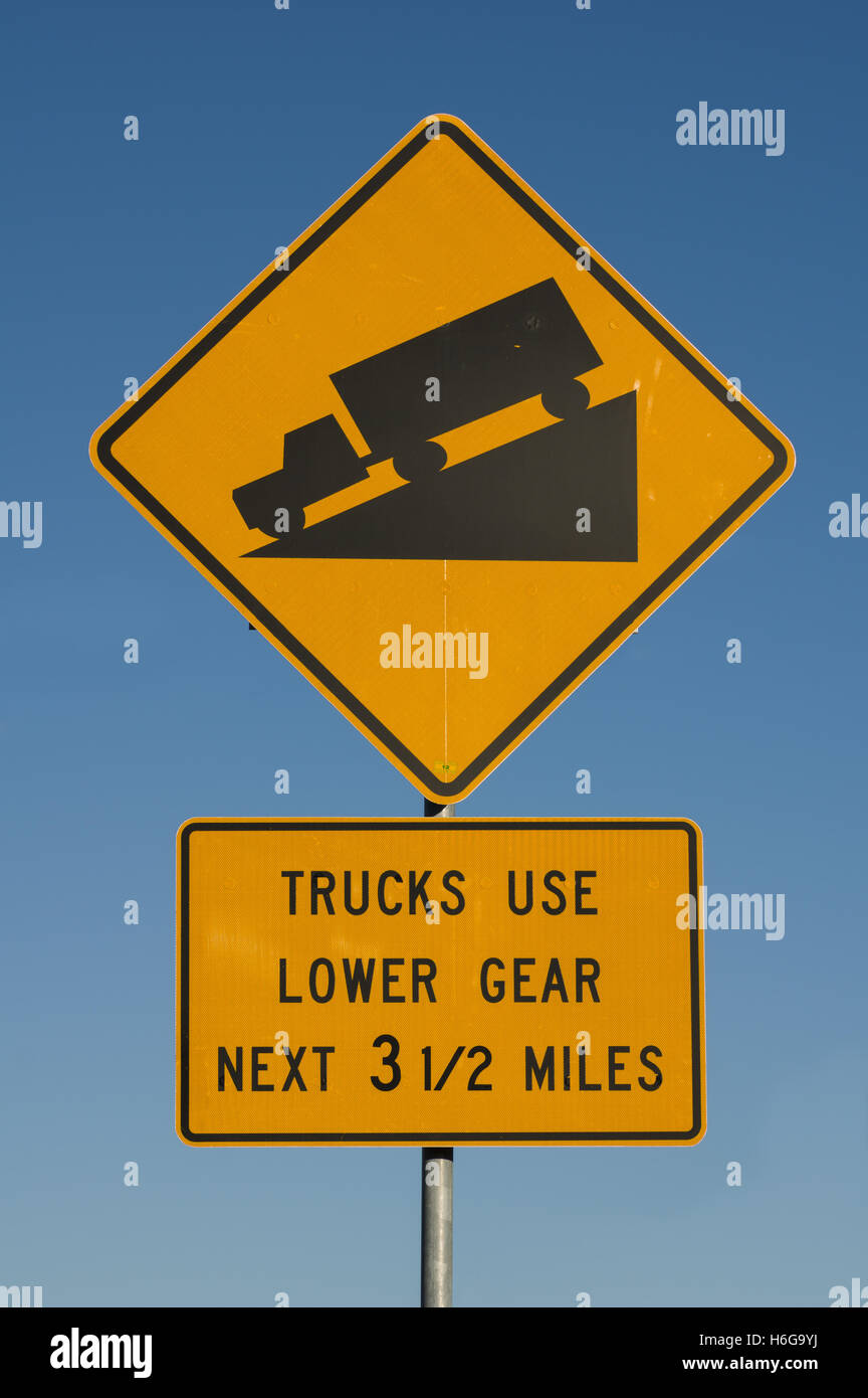 steep hill trucks use lower gear road sign with blue sky background ...