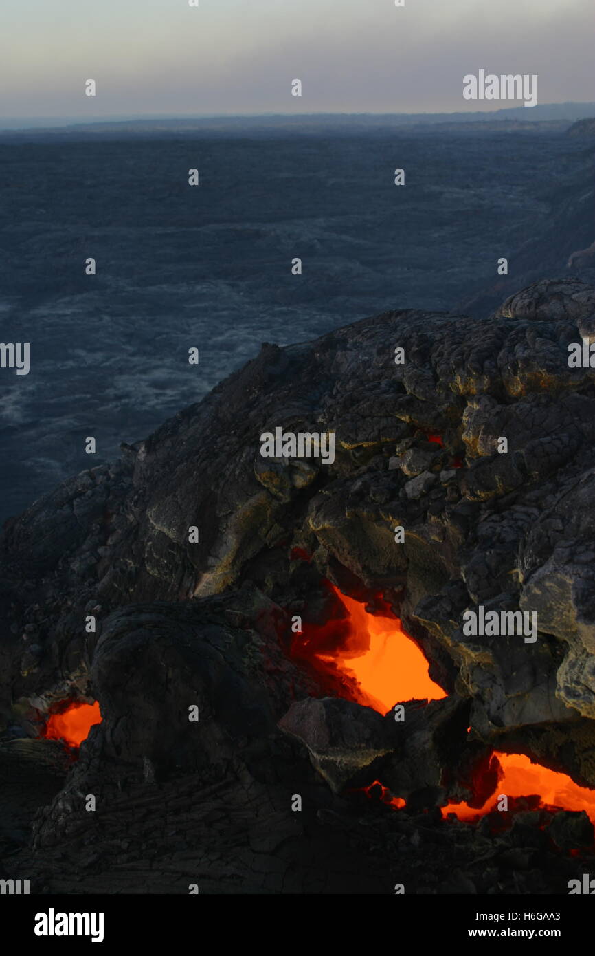 skylights in lava tube reveal the red hot liquid lava traveling through ...