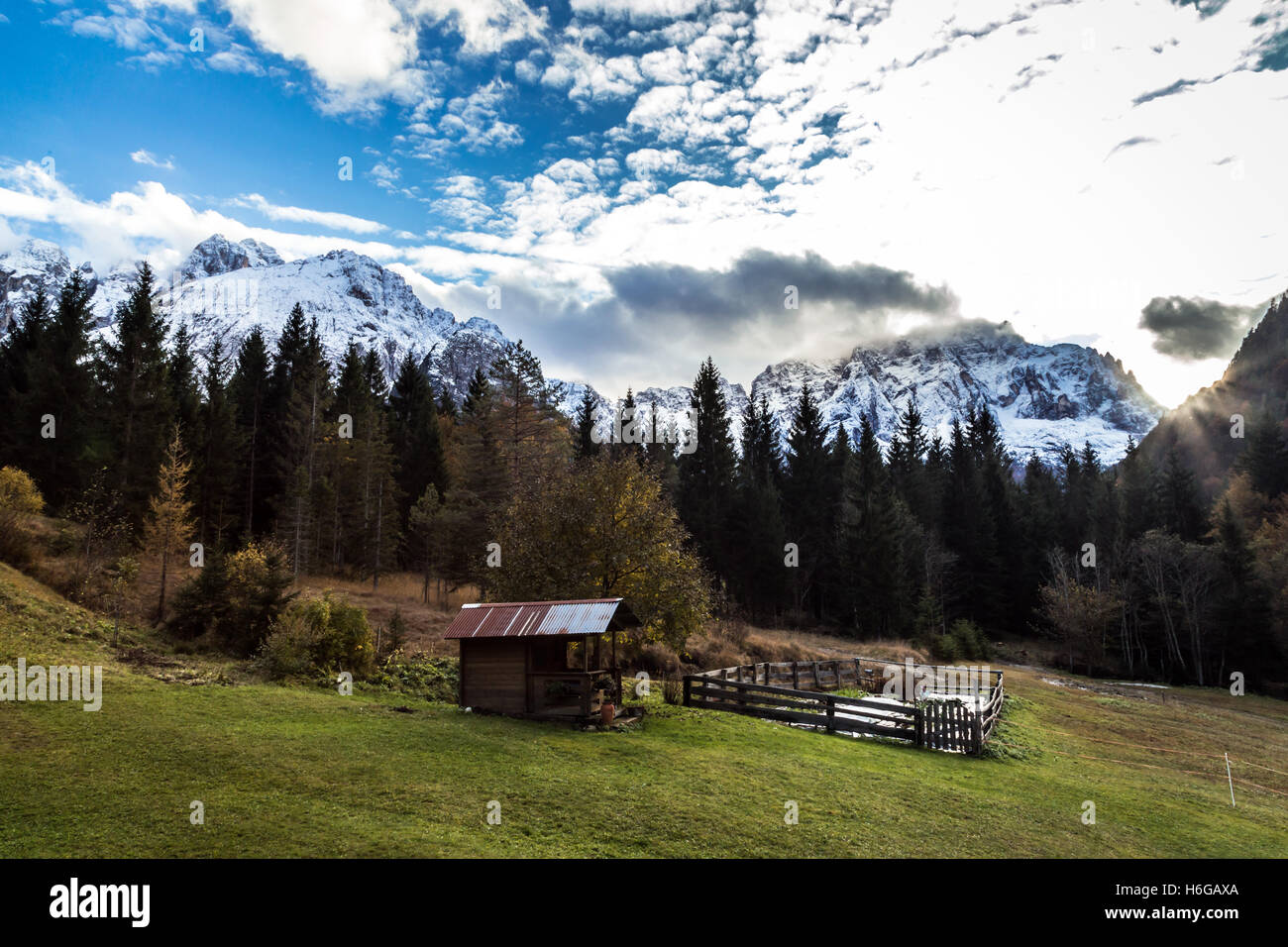 an alpine hut in the valley during a colorful sunset Stock Photo - Alamy
