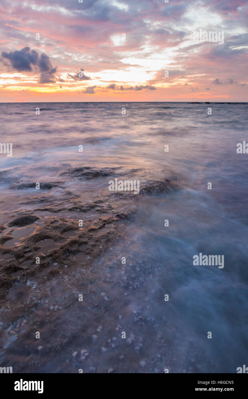 Long exposure sea and rocks at twilight Stock Photo - Alamy