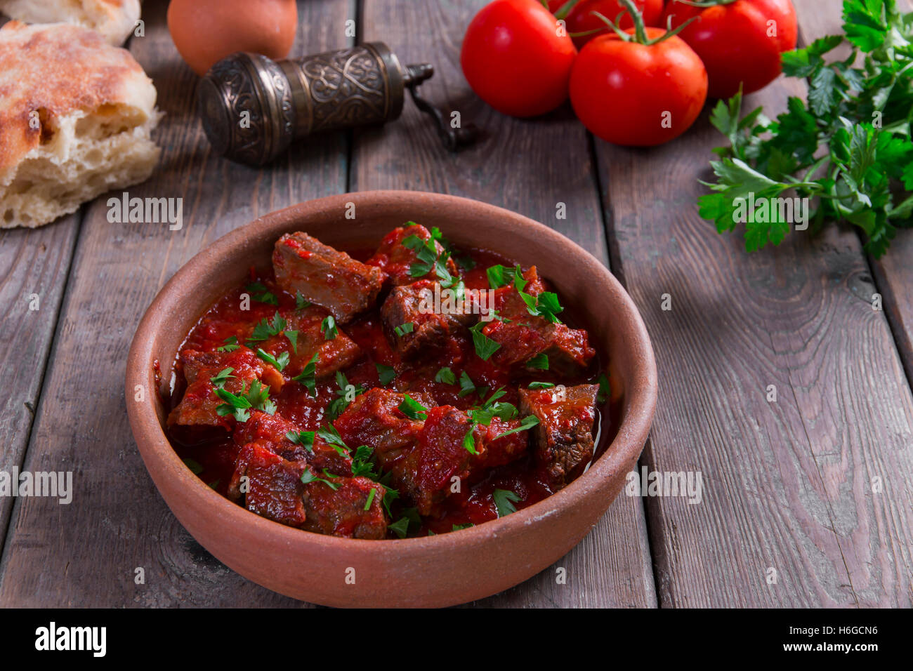 meat in tomato sauce beef roast in a clay bowl Stock Photo - Alamy