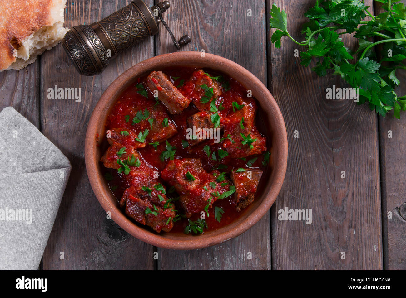 meat in tomato sauce beef roast in a clay bowl Stock Photo - Alamy