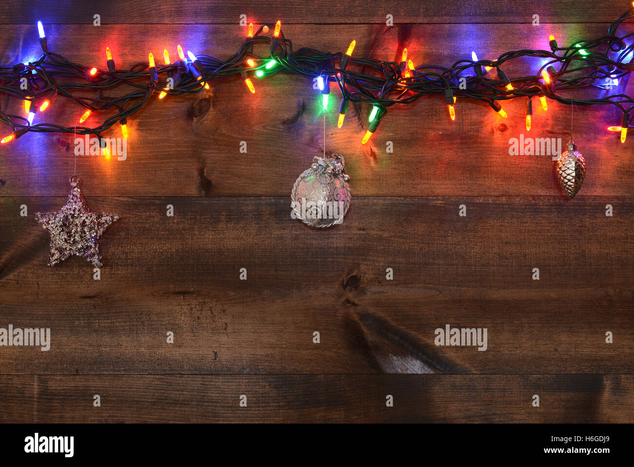 three silver ornaments and Christmas lights Stock Photo - Alamy