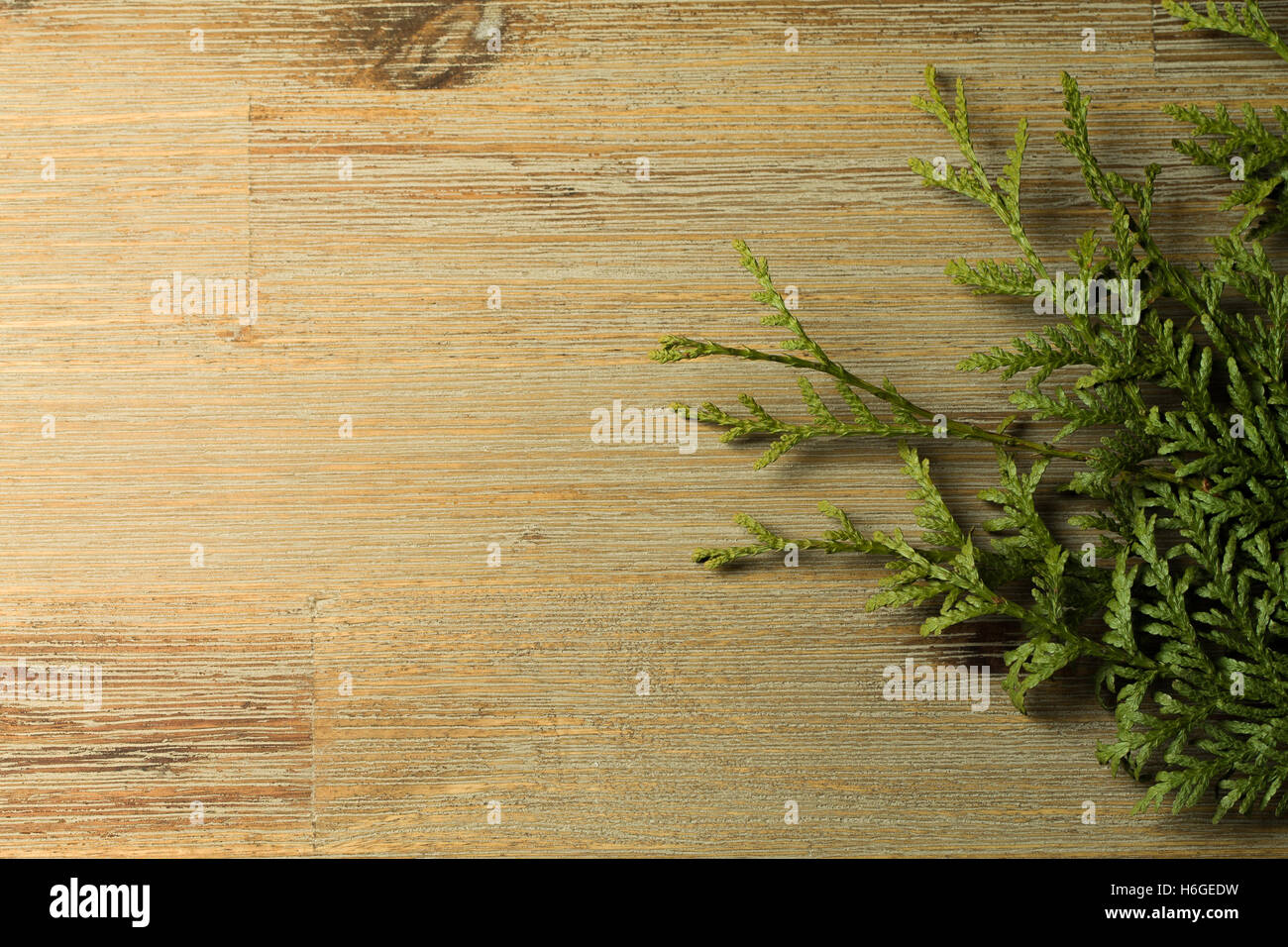 Branch over wooden table background with copy space Stock Photo - Alamy
