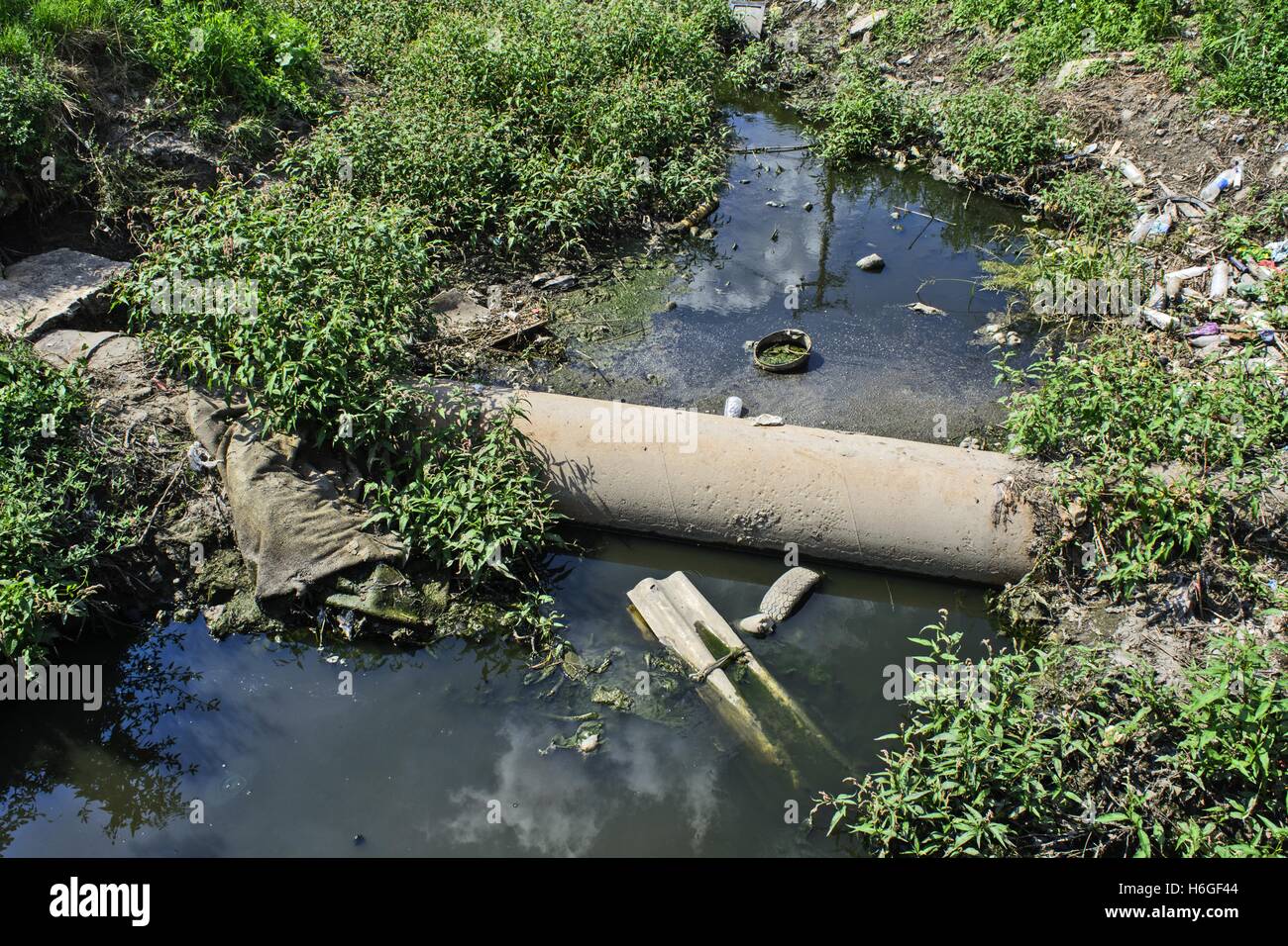 Very polluted river that runs through the village Stock Photo - Alamy