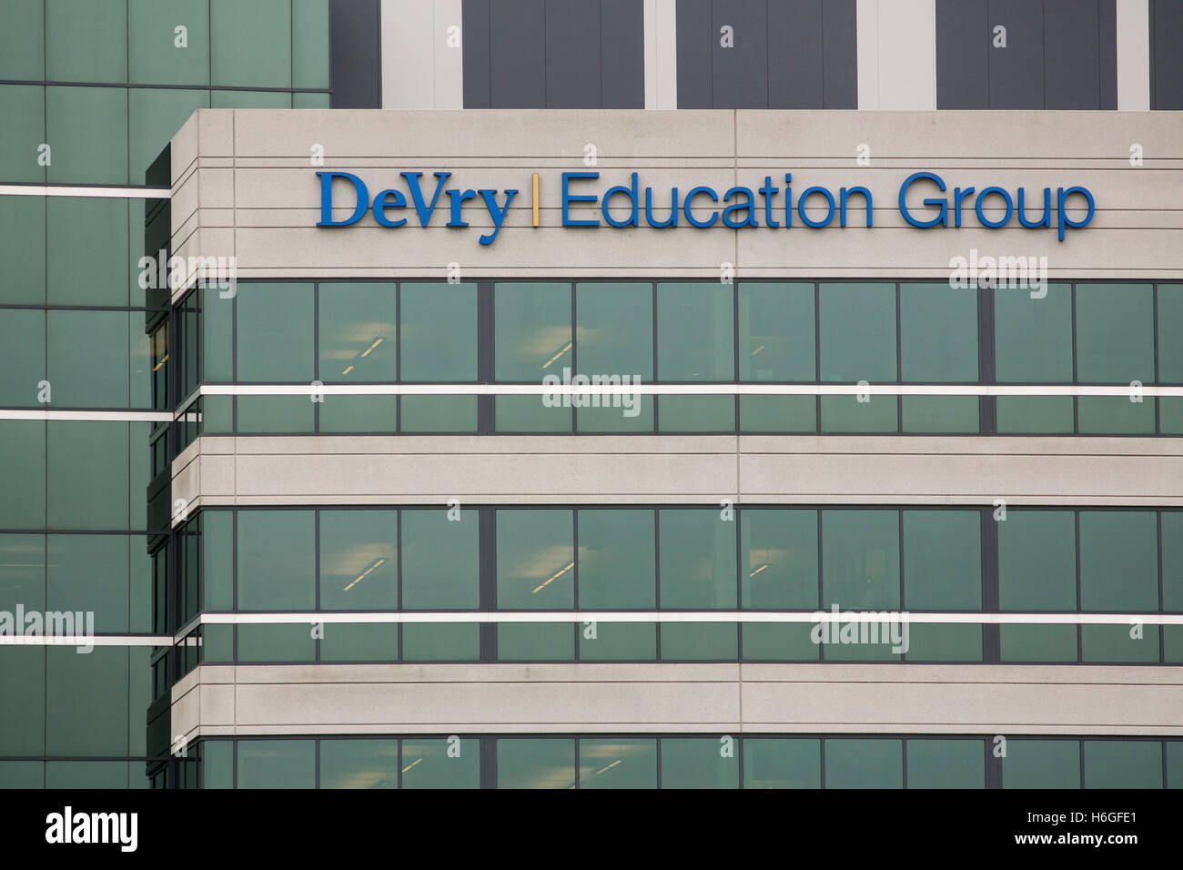 A logo sign outside of the headquarters of the DeVry Education Group in ...