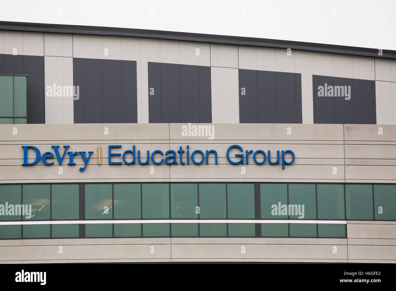 A logo sign outside of the headquarters of the DeVry Education Group in ...
