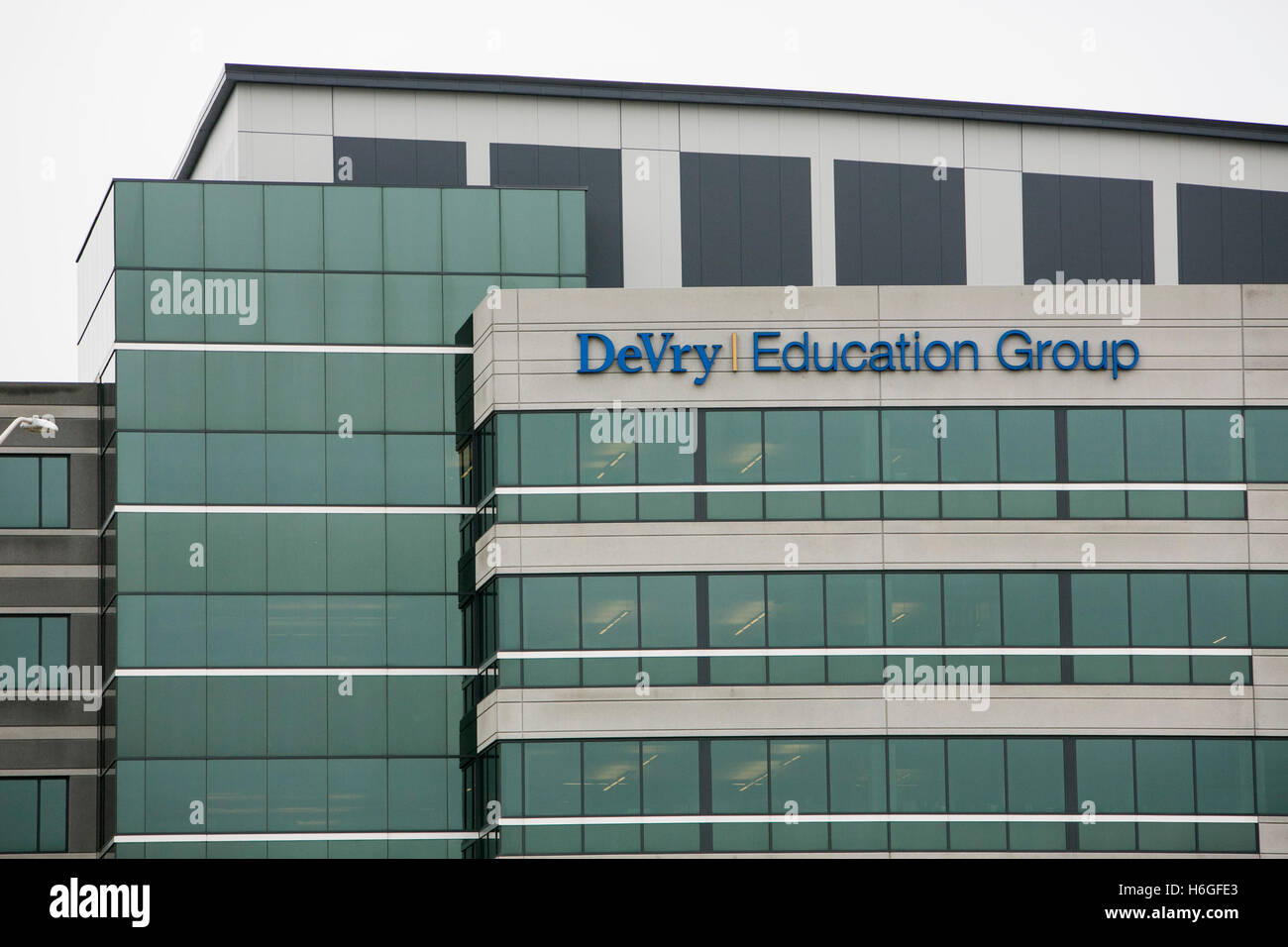 A logo sign outside of the headquarters of the DeVry Education Group in ...