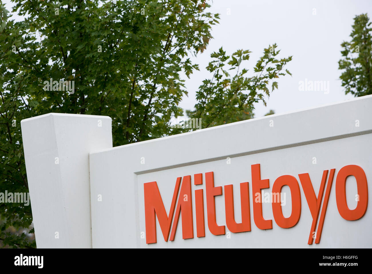 A logo sign outside of a facility occupied by the Mitutoyo America ...
