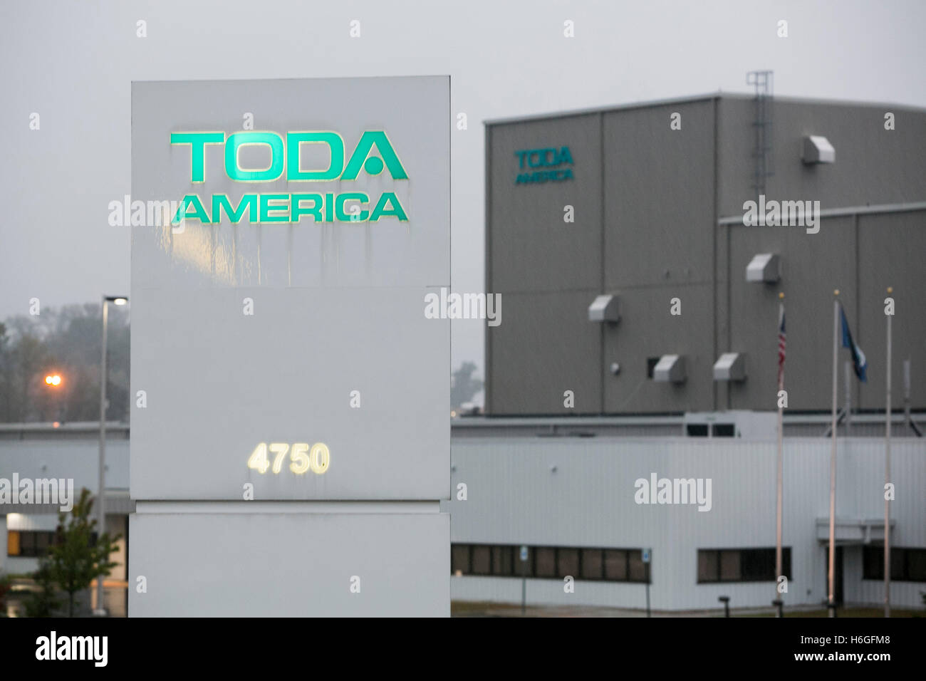 A logo sign outside of a facility occupied by TODA America, Inc., a ...