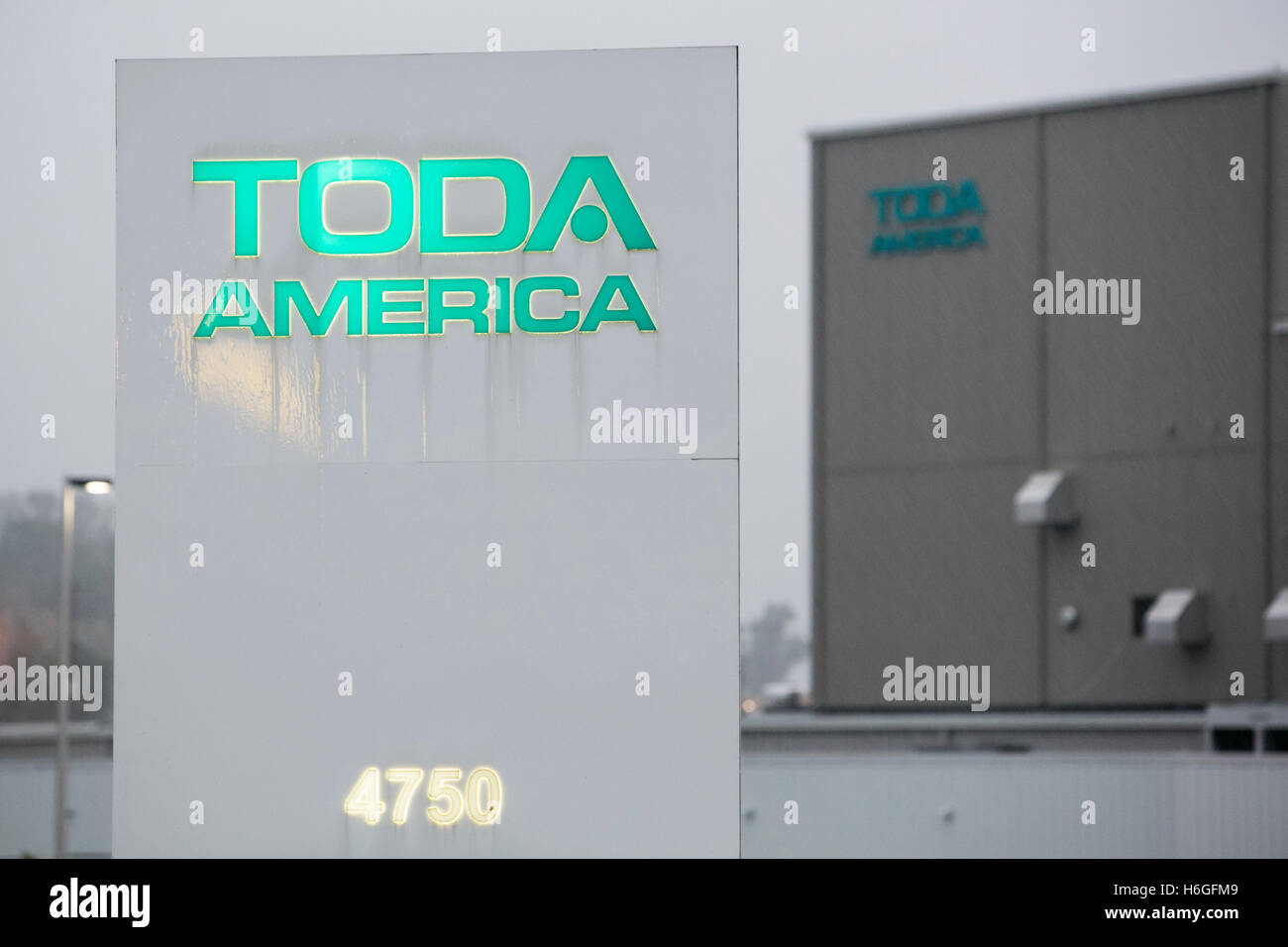 A logo sign outside of a facility occupied by TODA America, Inc., a ...