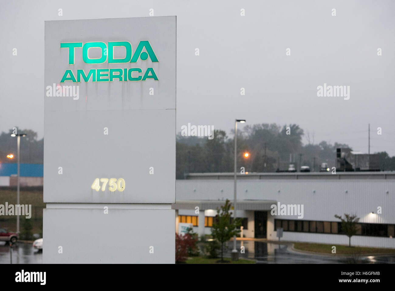 A logo sign outside of a facility occupied by TODA America, Inc., a ...