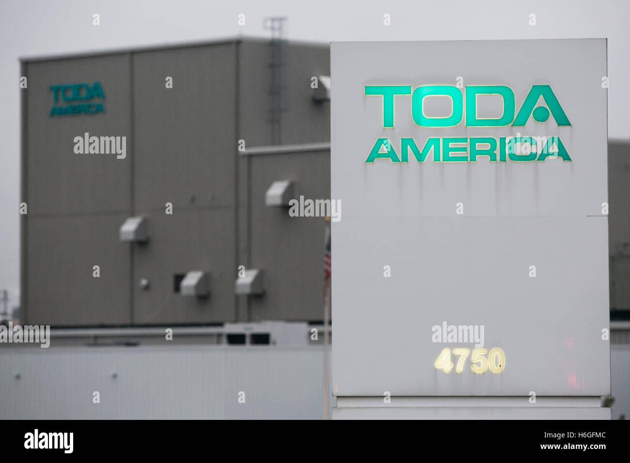 A logo sign outside of a facility occupied by TODA America, Inc., a ...