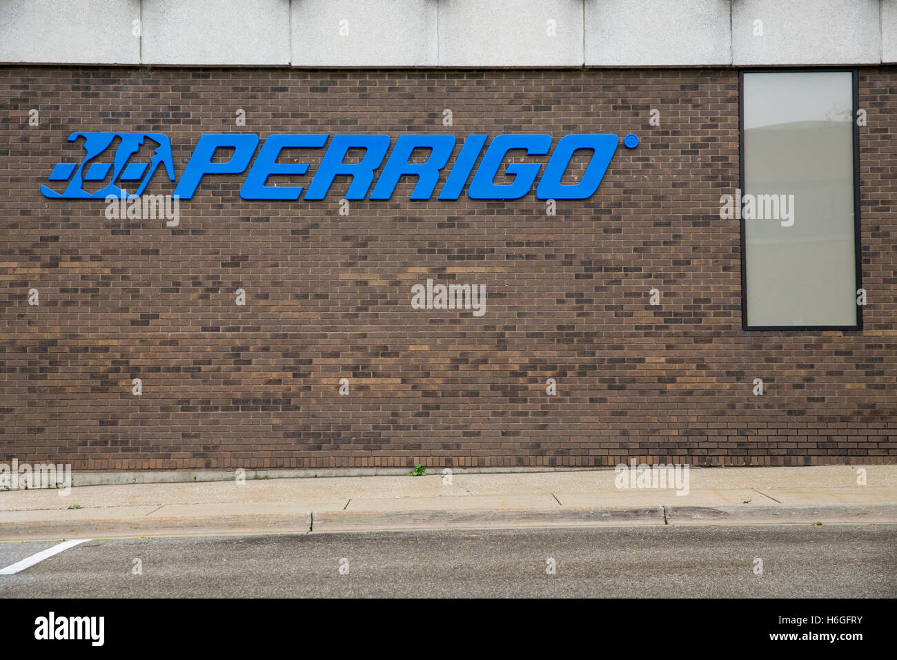 A logo sign outside of a facility occupied by the Perrigo Company in ...