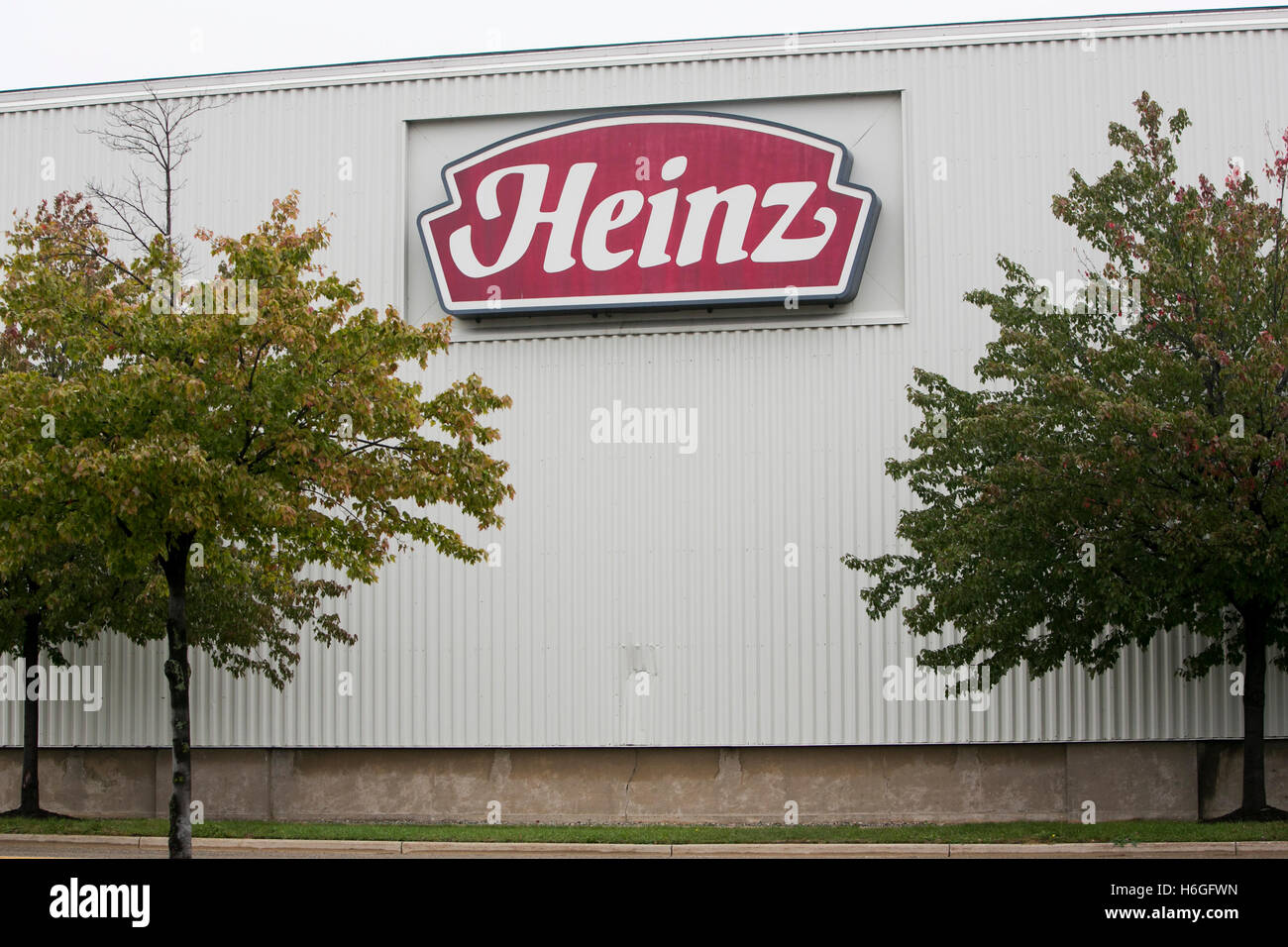 A logo sign outside of a facility occupied by Heinz in Holland ...