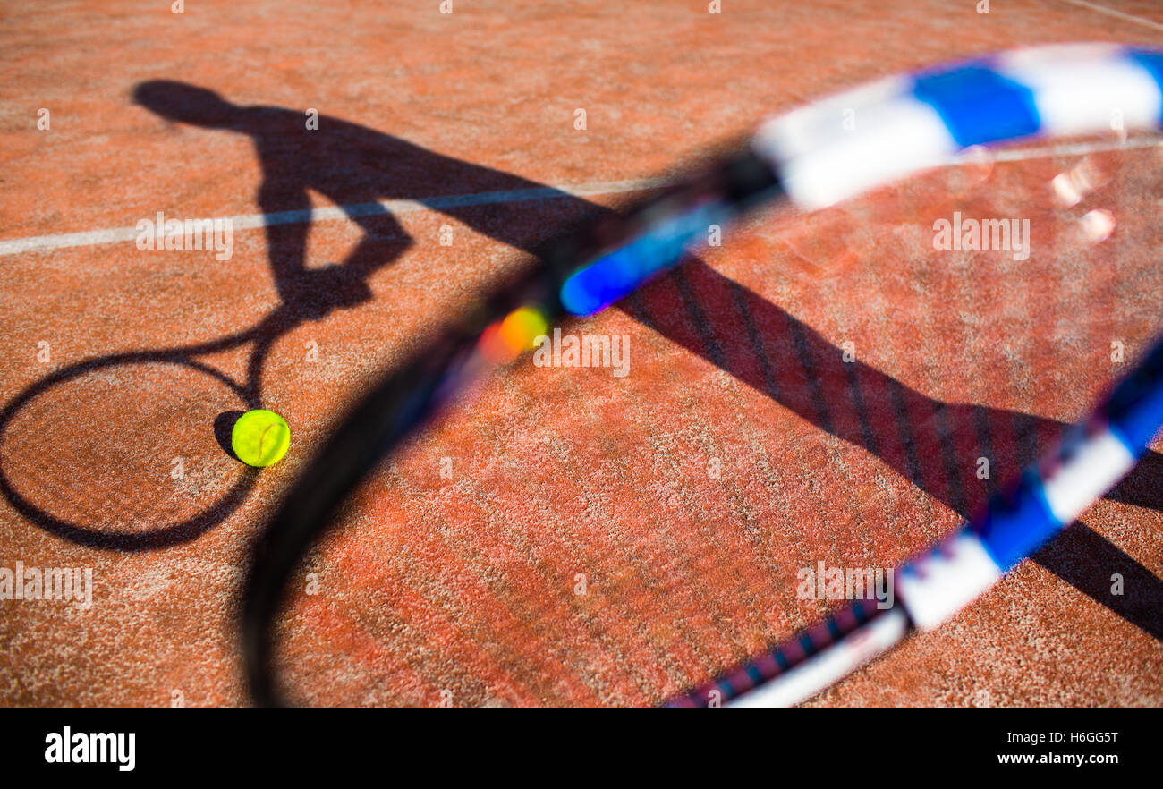 Shadow of a tennis player in action on a tennis court (conceptual image ...