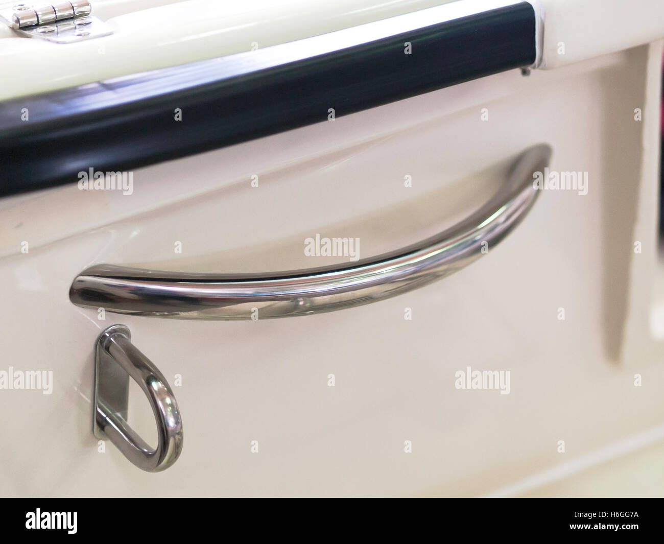 Stainless steel climbing handle on a boat Stock Photo - Alamy