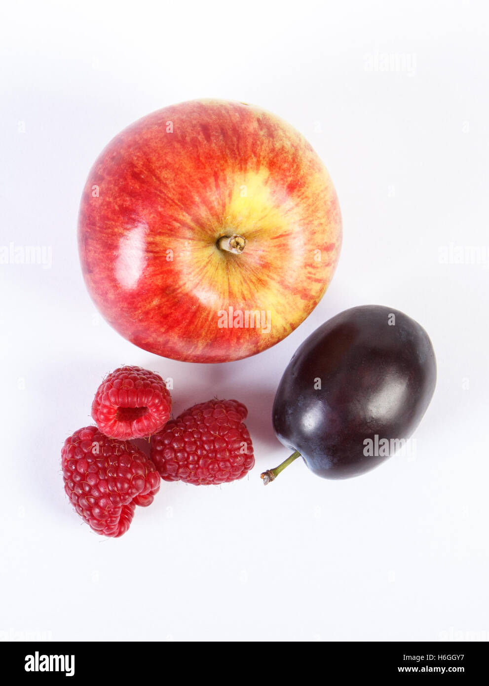 Fresh ripe apple, raspberries and plum on white background, healthy ...