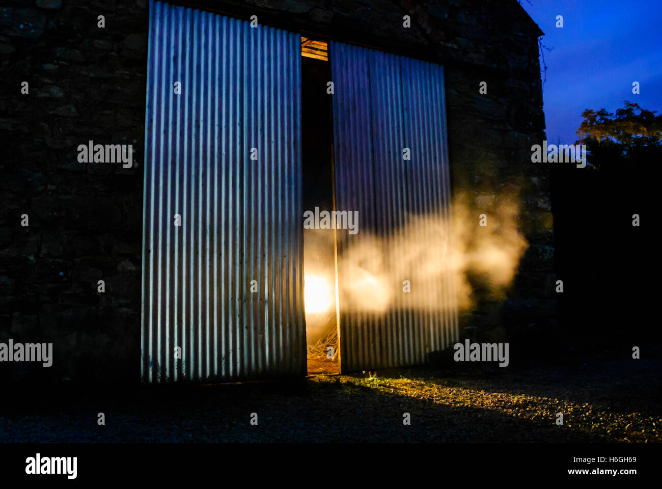 Light shines through smoke coming out from half open doors of an old ... Light shines through smoke coming out from half open doors of an old ...