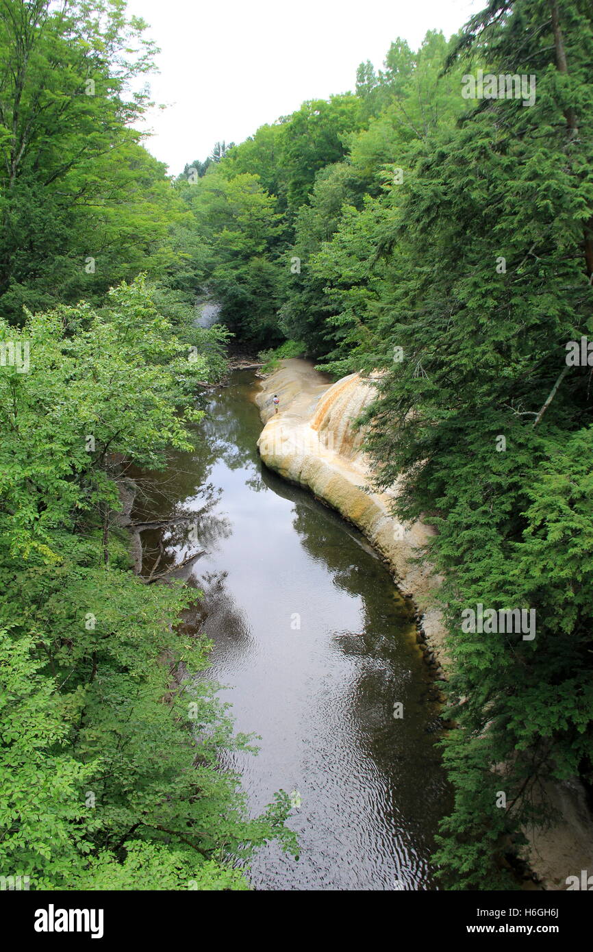 Vertical image of steep drop that leads down to a meandering body of ...