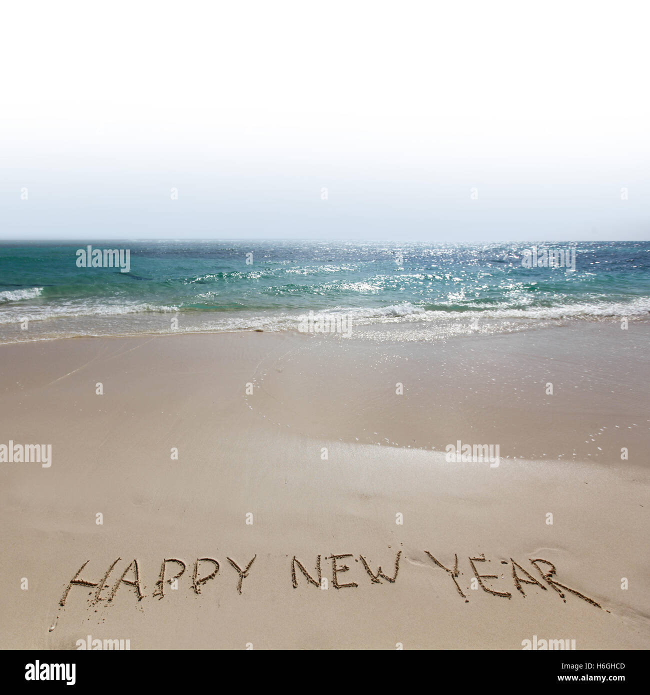 Happy new year handwriting on tropical sea beach Stock Photo - Alamy