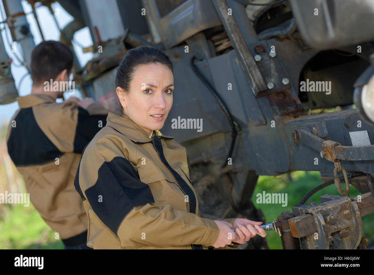 agricultural mechanics checking tractors condition before harvesting ...