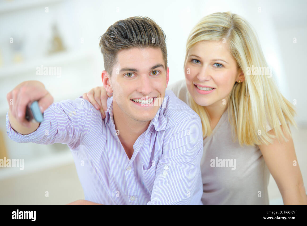 couple with remote Stock Photo - Alamy