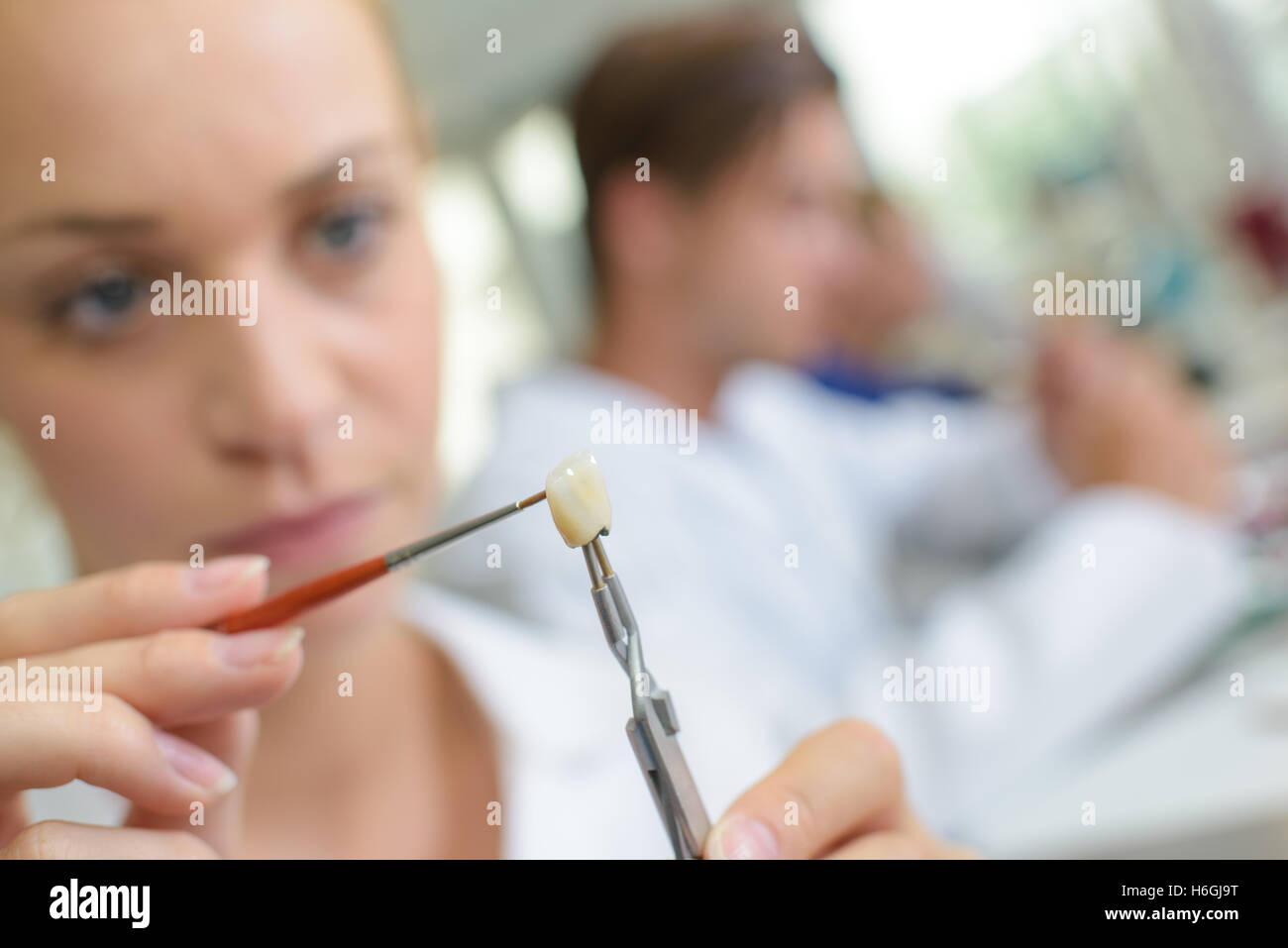 Female dental technician working on individual tooth Stock Photo - Alamy