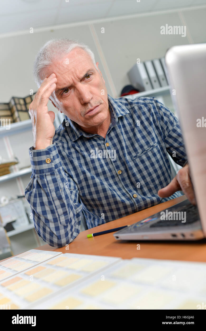 Senior office worker having a few computer issues Stock Photo - Alamy